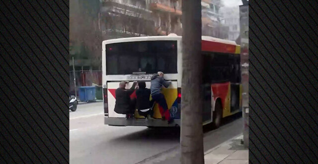 Thessaloniki: Youngsters jung from the back of a moving bus, getting on ...